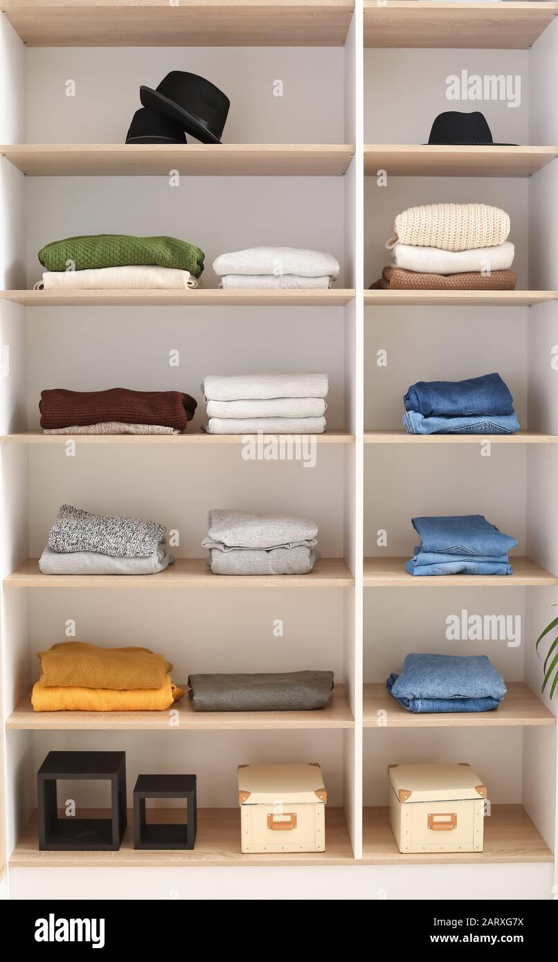 Wardrobe with stacks of clean clothes Stock Photo - Alamy