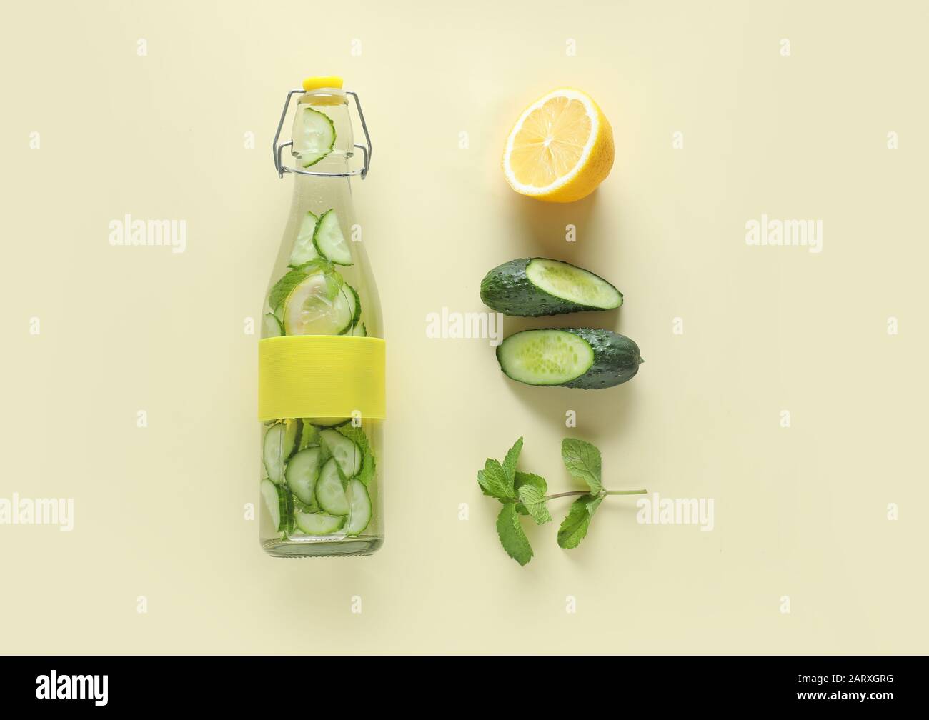 Bottle of healthy infused water with ingredients on light background ...