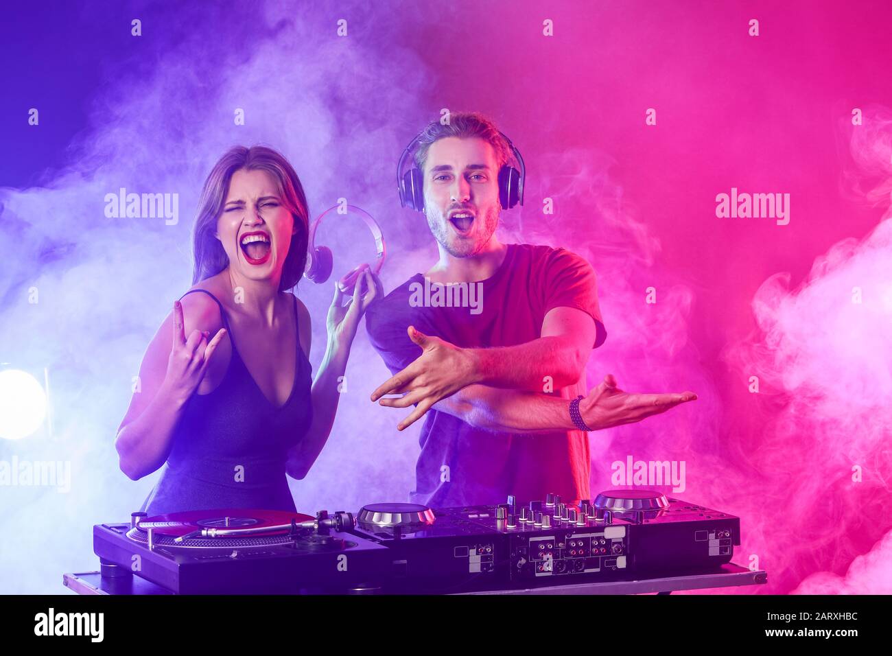 Young djs playing music in nightclub Stock Photo - Alamy
