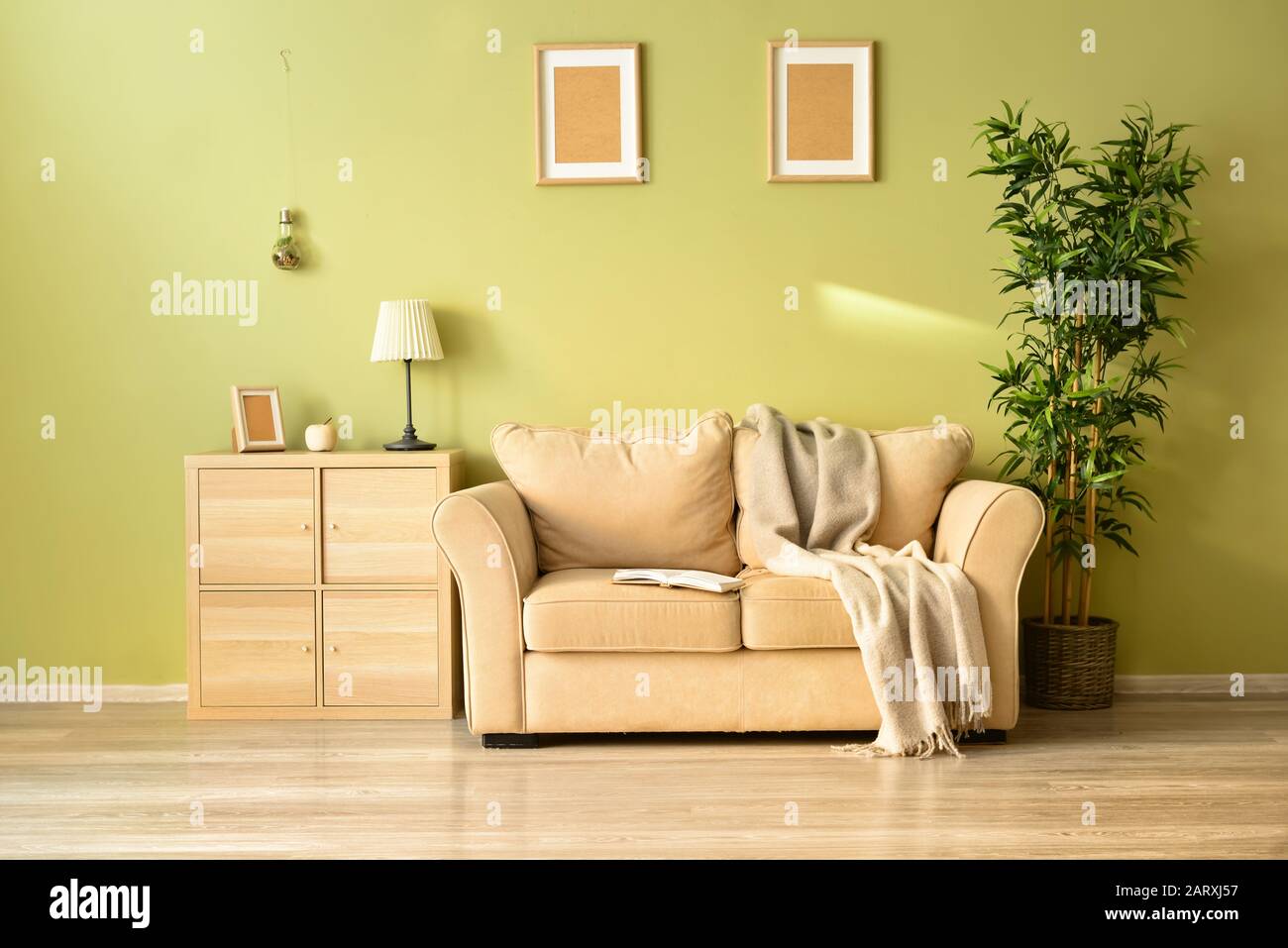 Stylish interior of room with comfortable sofa Stock Photo - Alamy