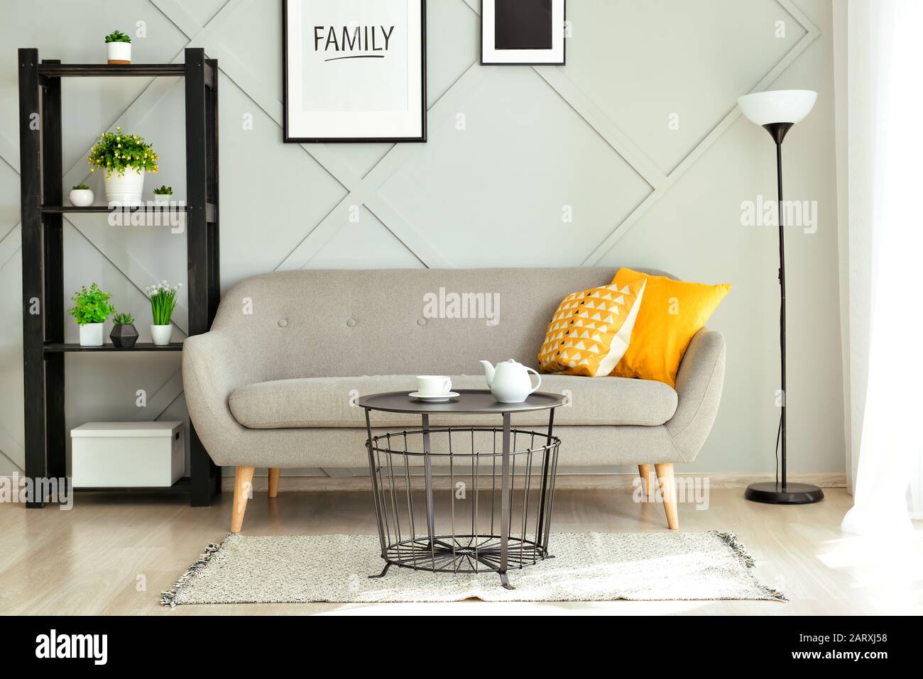 Stylish interior of room with comfortable sofa Stock Photo - Alamy