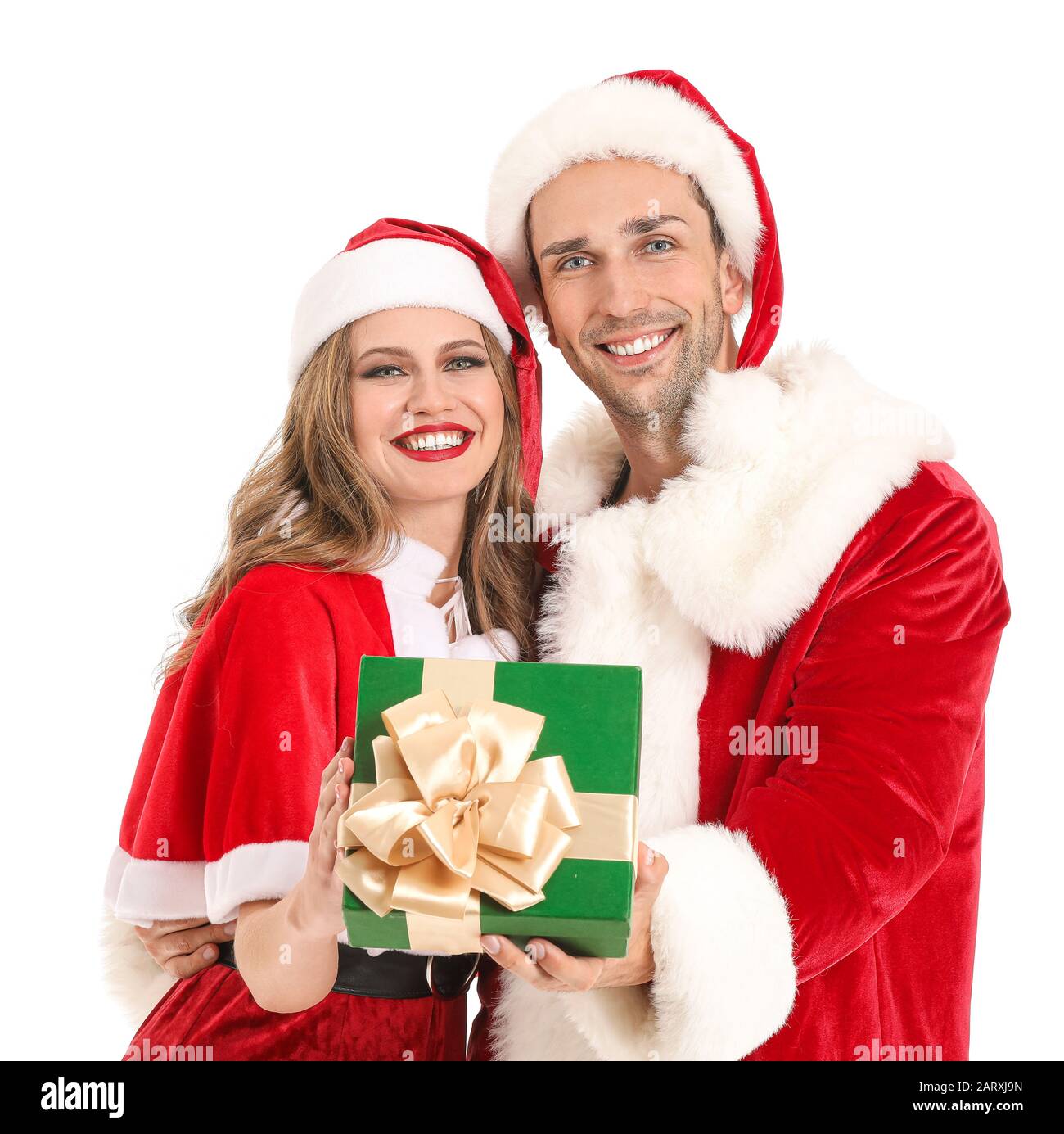 Young couple dressed as Santa Claus with Christmas gift on white ...