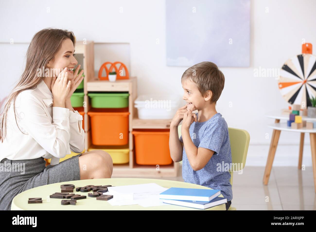 Cute little boy at speech therapist office Stock Photo - Alamy
