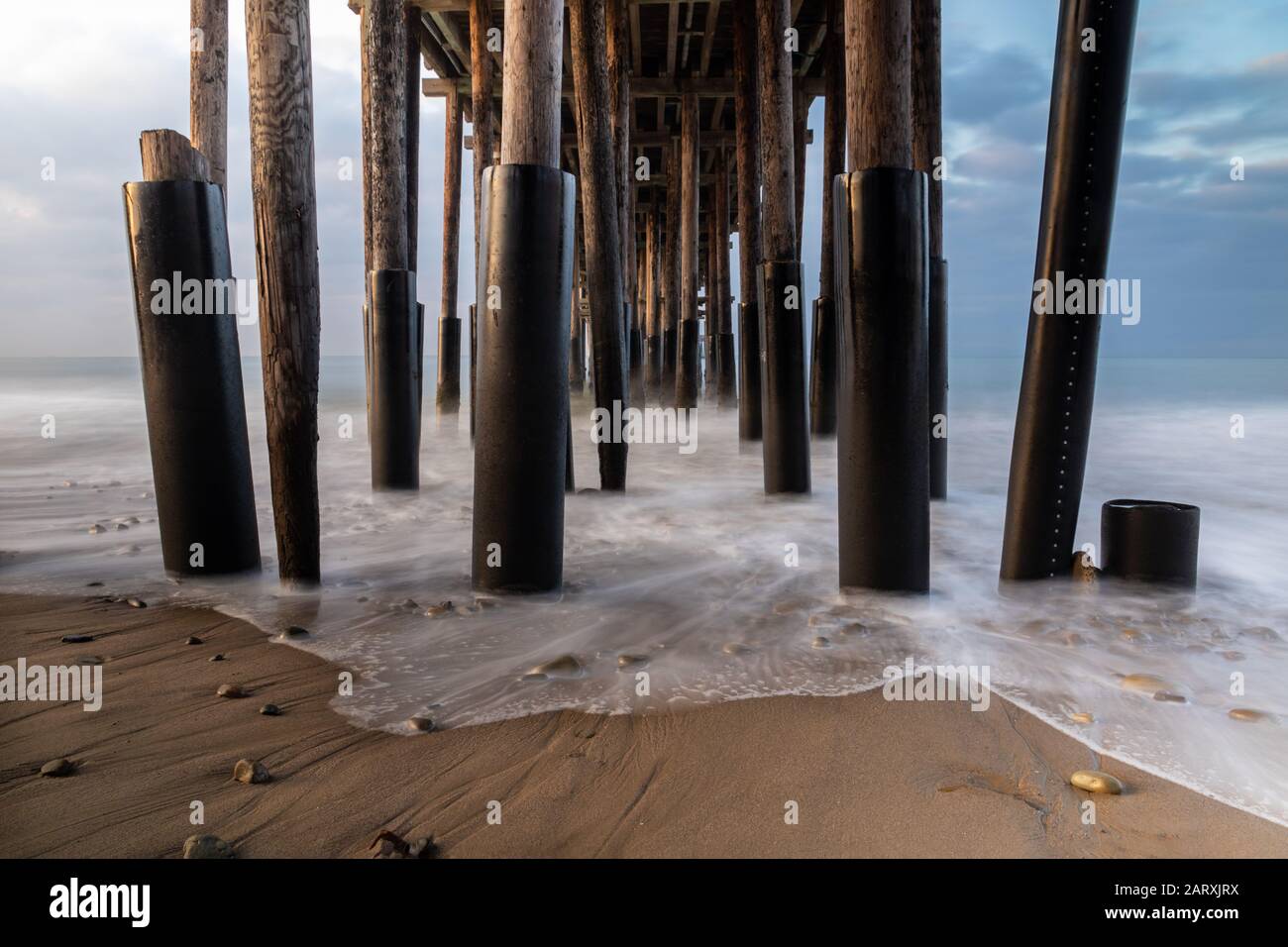 Closeup of pillars, Ventura Pier, Ventura, California. Early light from ...