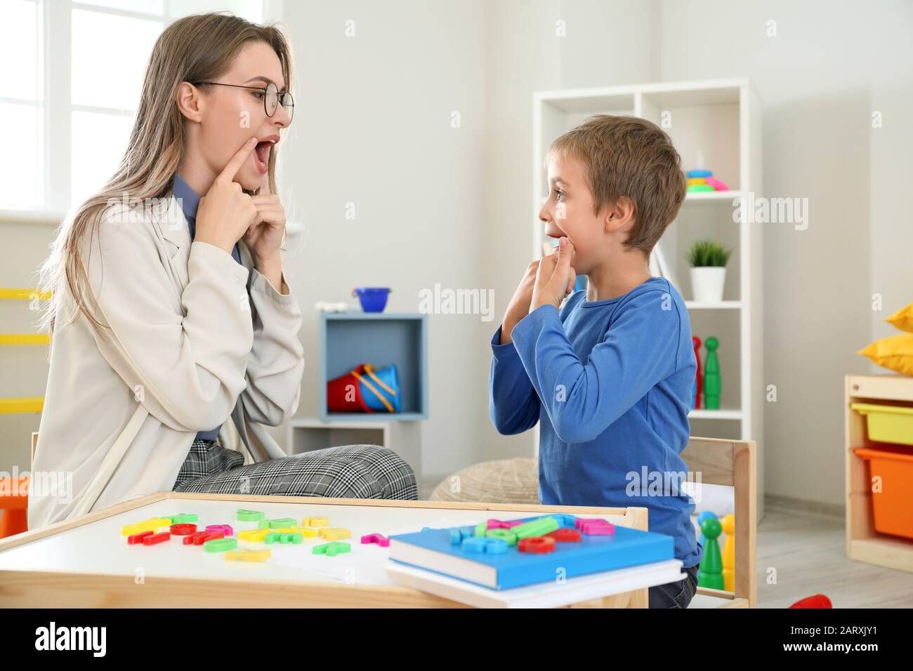 Cute little boy at speech therapist office Stock Photo - Alamy
