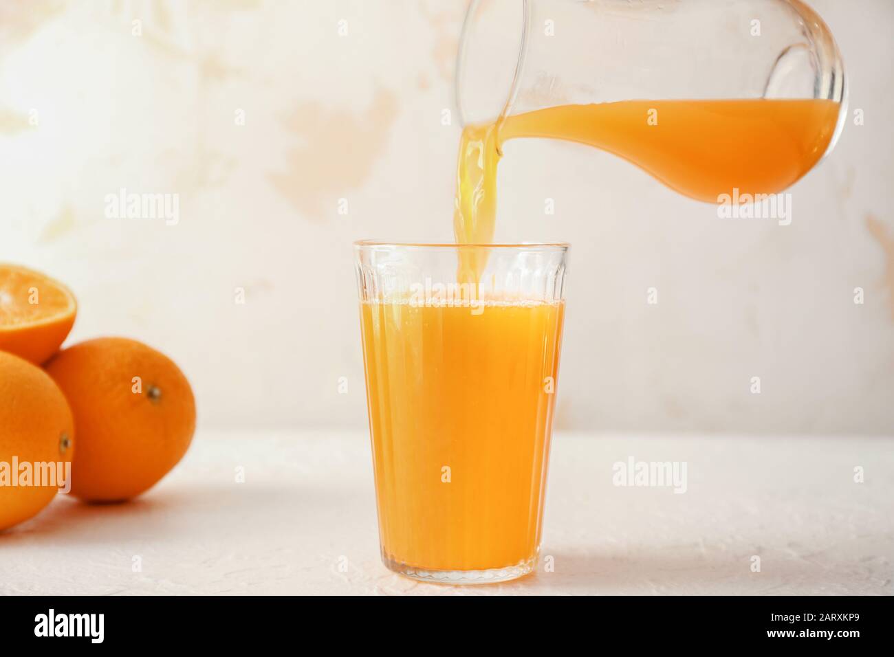 Orange juice pouring from jug hi-res stock photography and images - Alamy