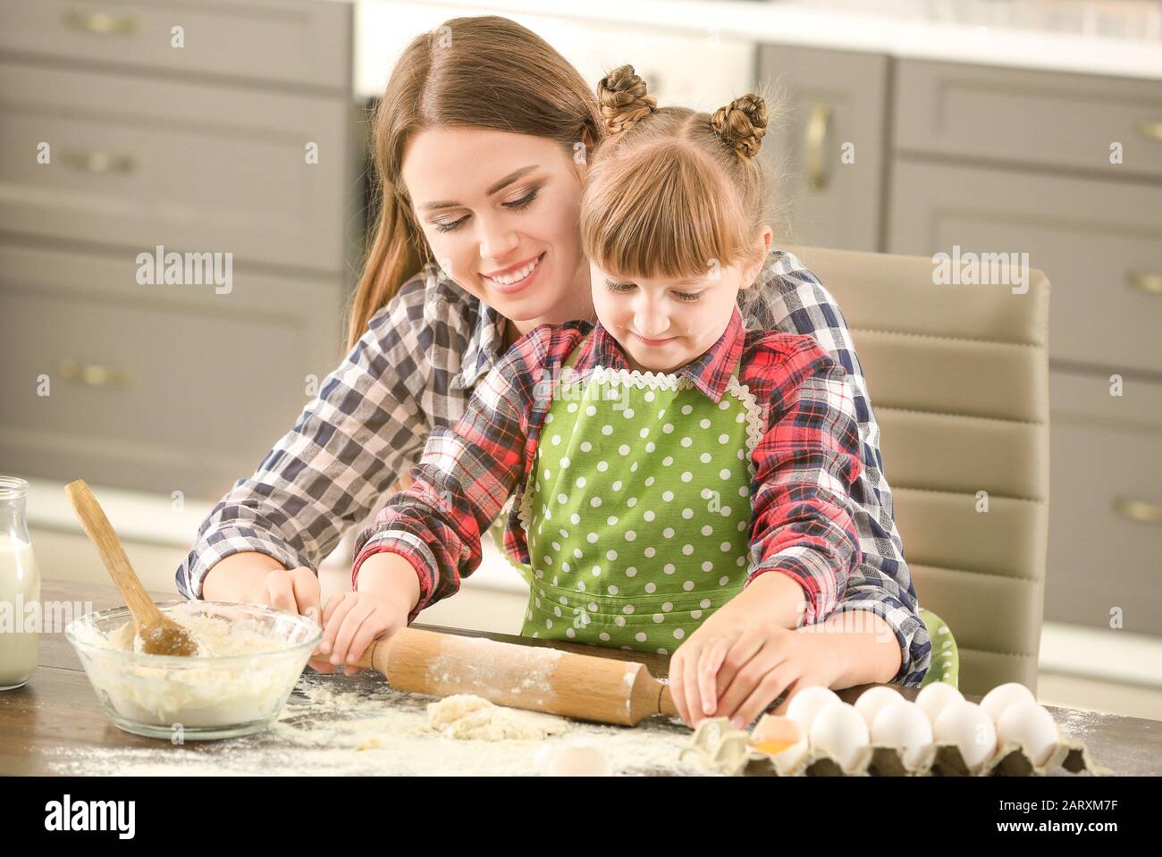 Happy mother and daughter cooking pastry at home Stock Photo - Alamy