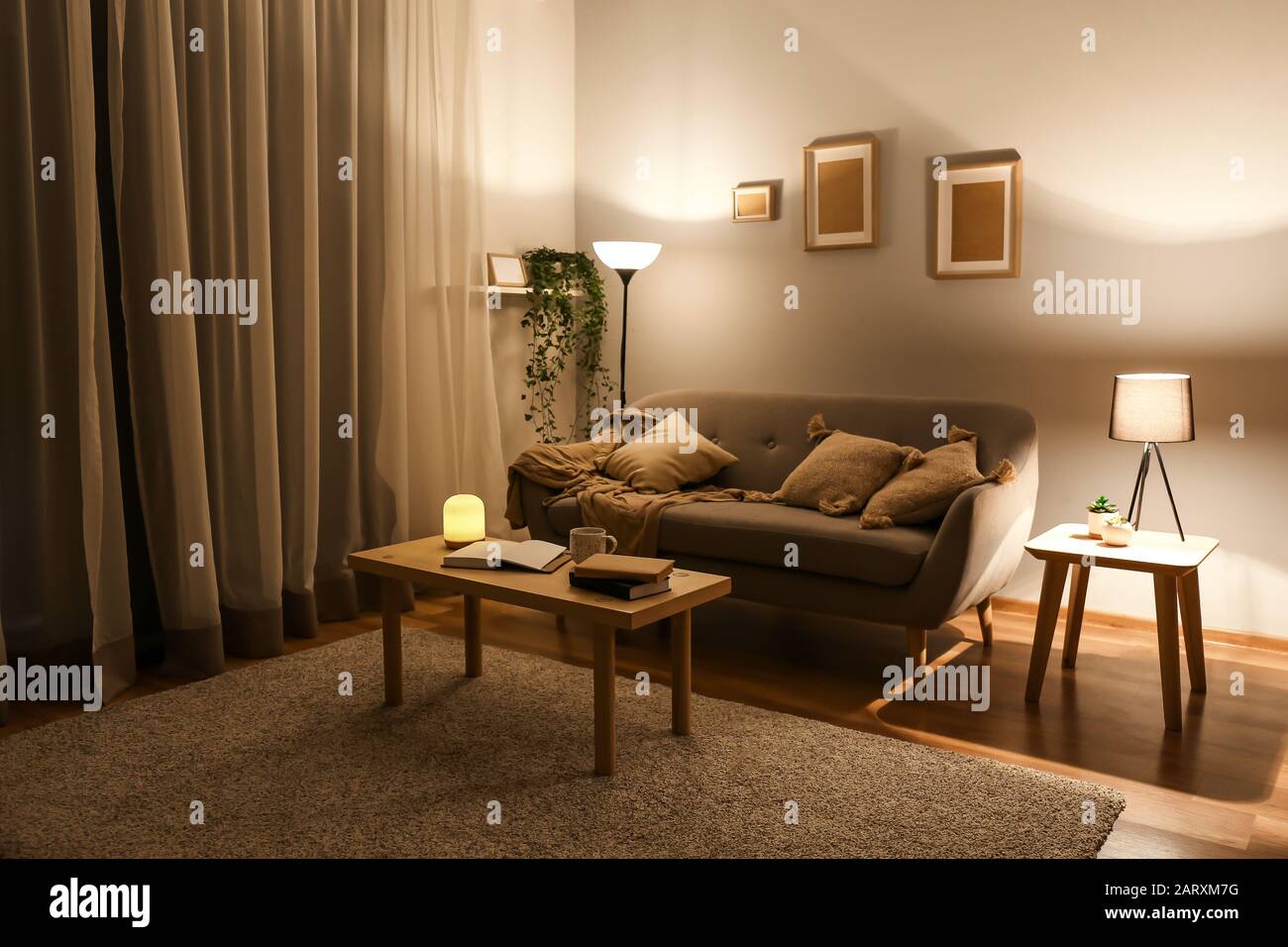 Stylish interior of living room at night Stock Photo - Alamy
