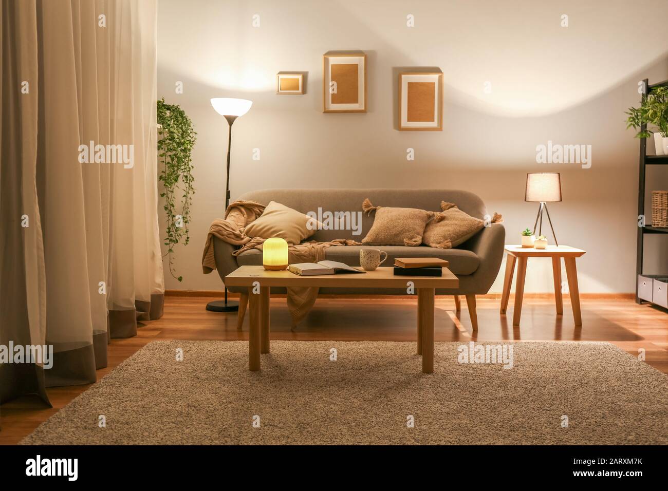 Stylish interior of living room at night Stock Photo - Alamy