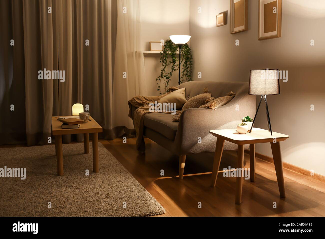 Stylish interior of living room at night Stock Photo - Alamy