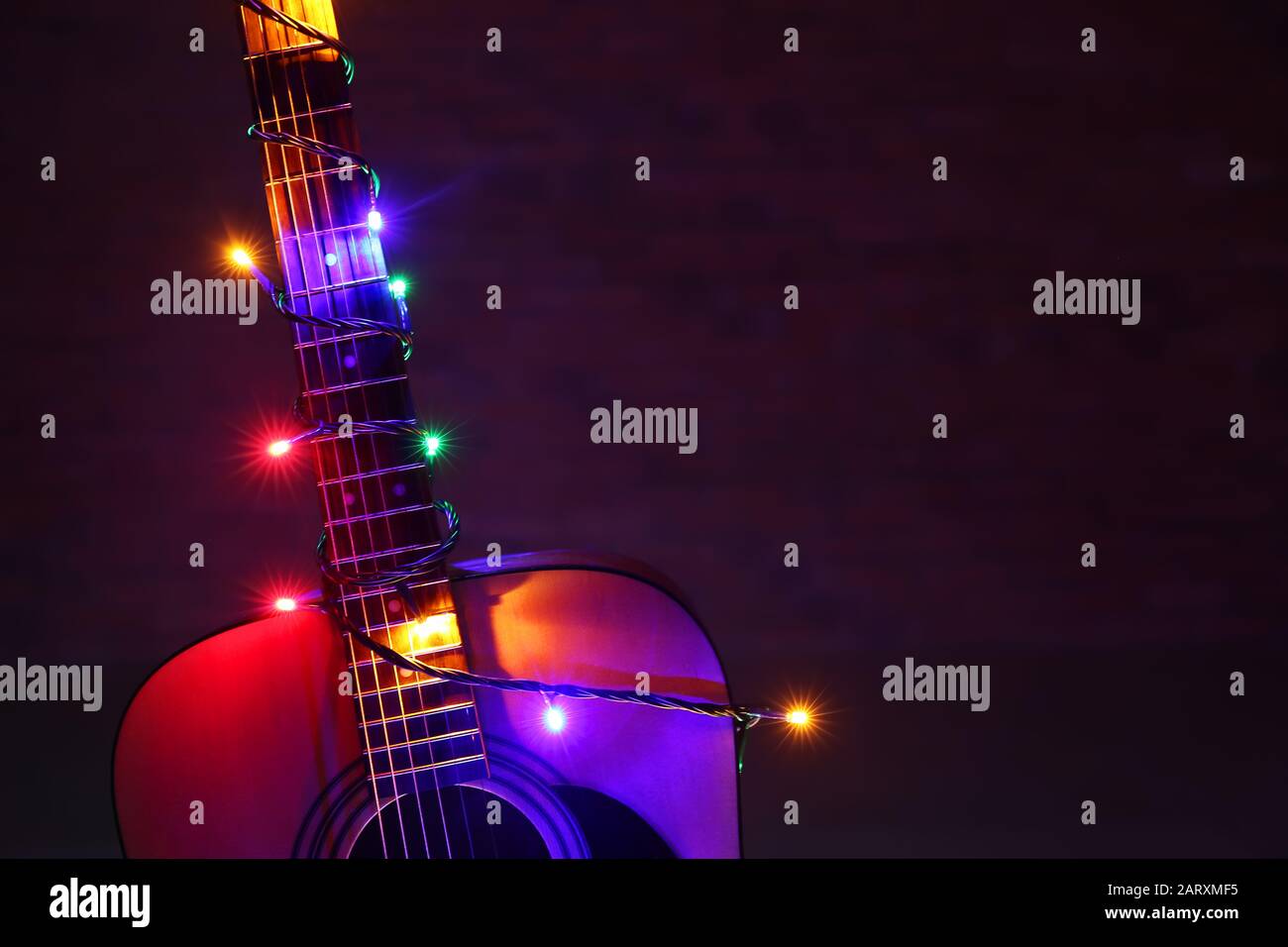 Acoustic guitar with Christmas lights against dark background Stock ...