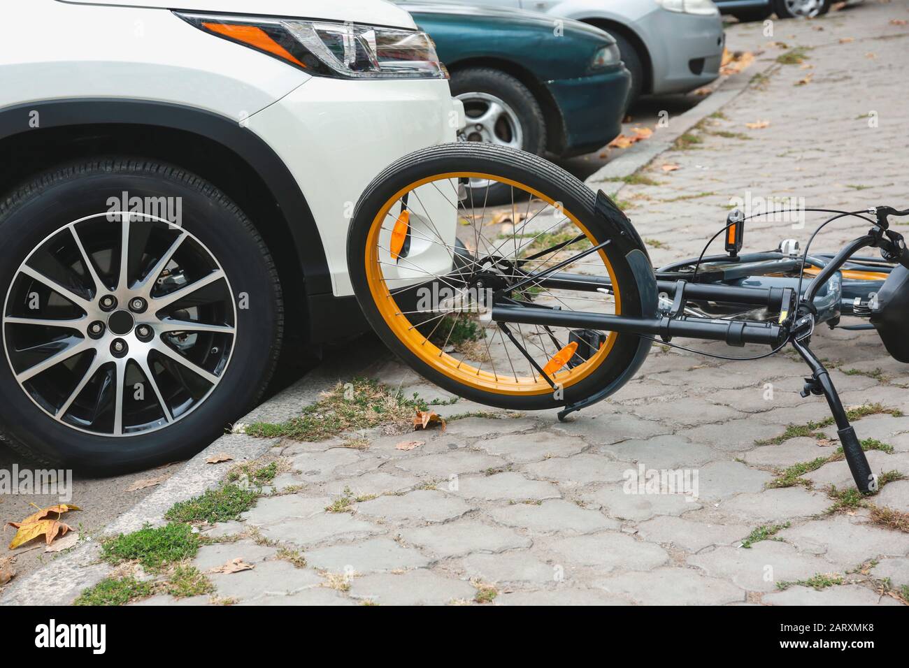 Accident between car and bicycle on city street Stock Photo - Alamy