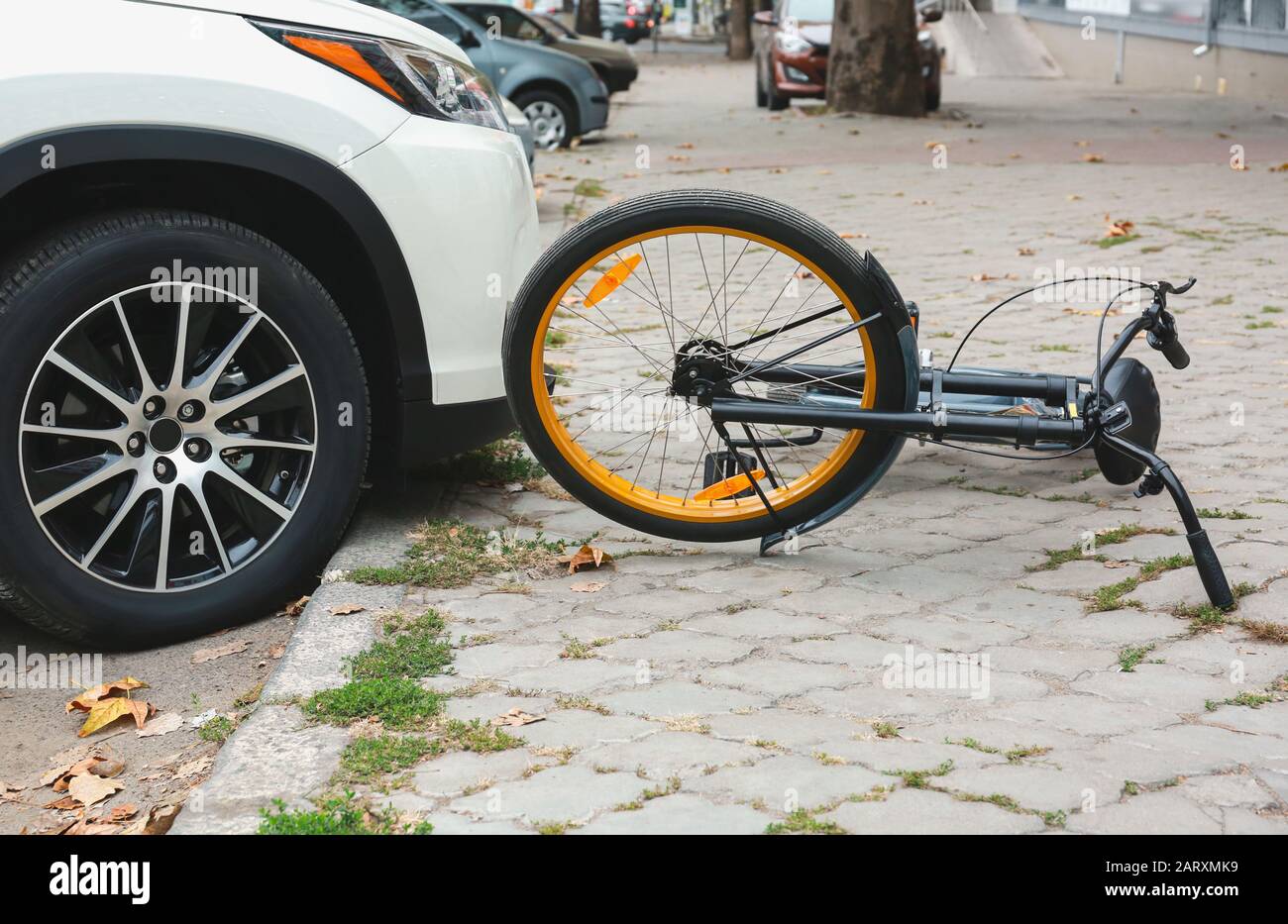 Accident between car and bicycle on city street Stock Photo - Alamy