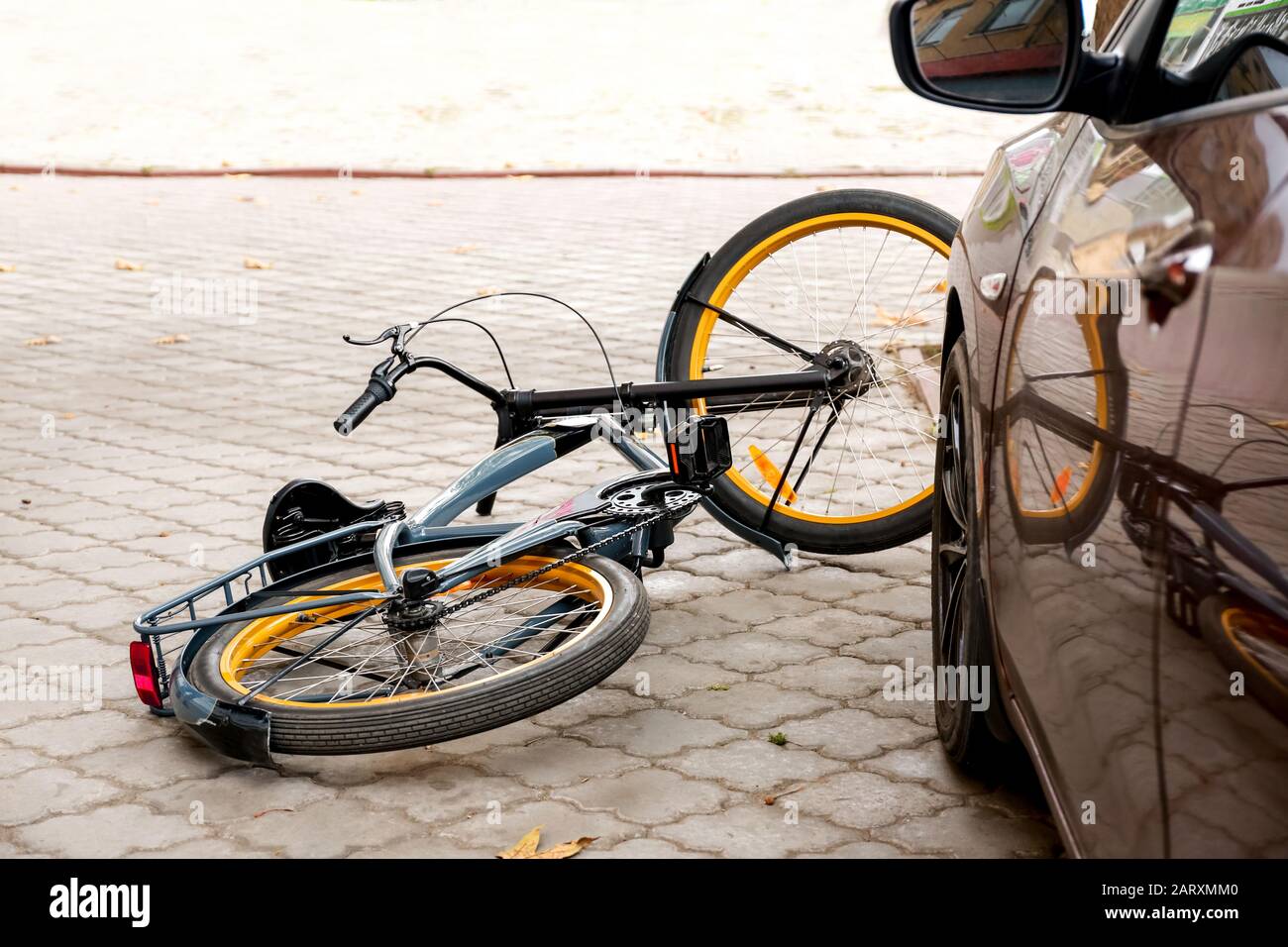 Accident between car and bicycle on city street Stock Photo - Alamy