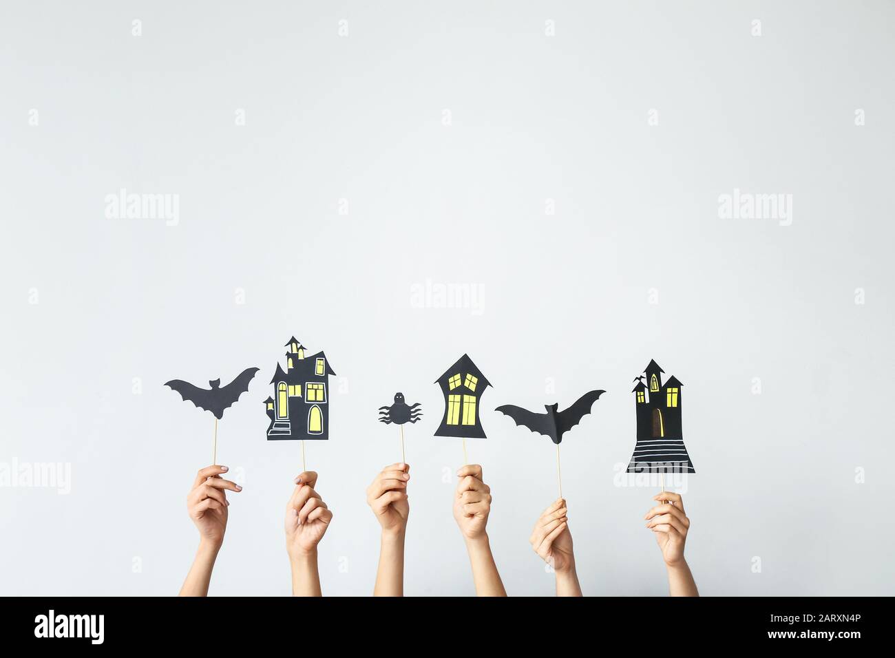 Many hands with Halloween decor on light background Stock Photo - Alamy