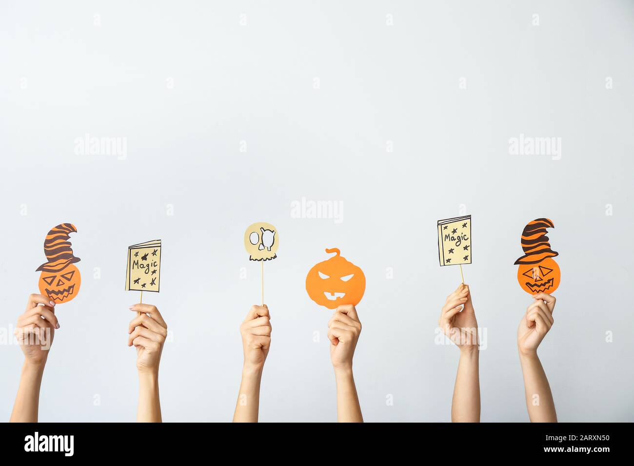 Many hands with Halloween decor on light background Stock Photo - Alamy