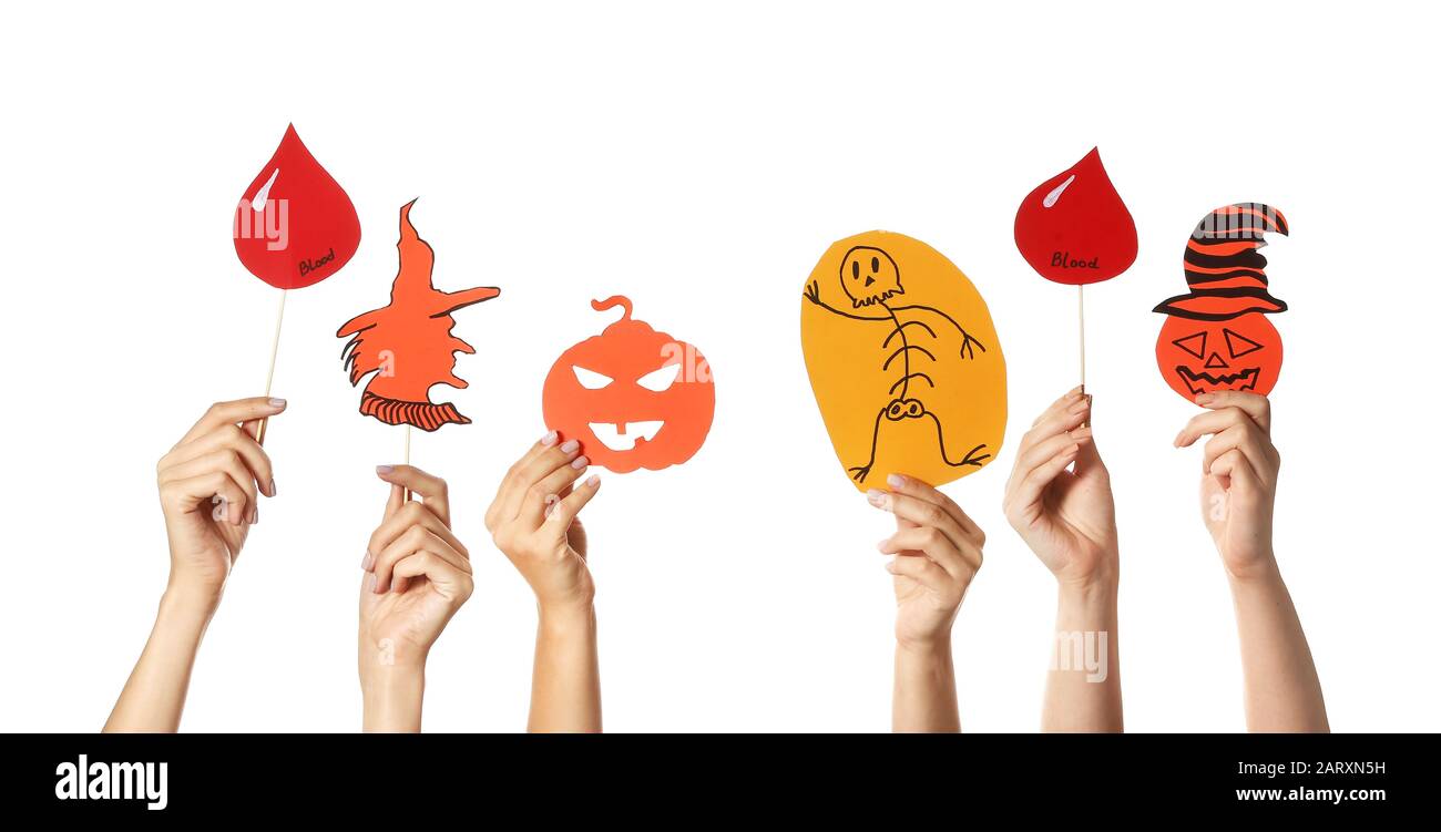 Many hands with Halloween decor on white background Stock Photo - Alamy