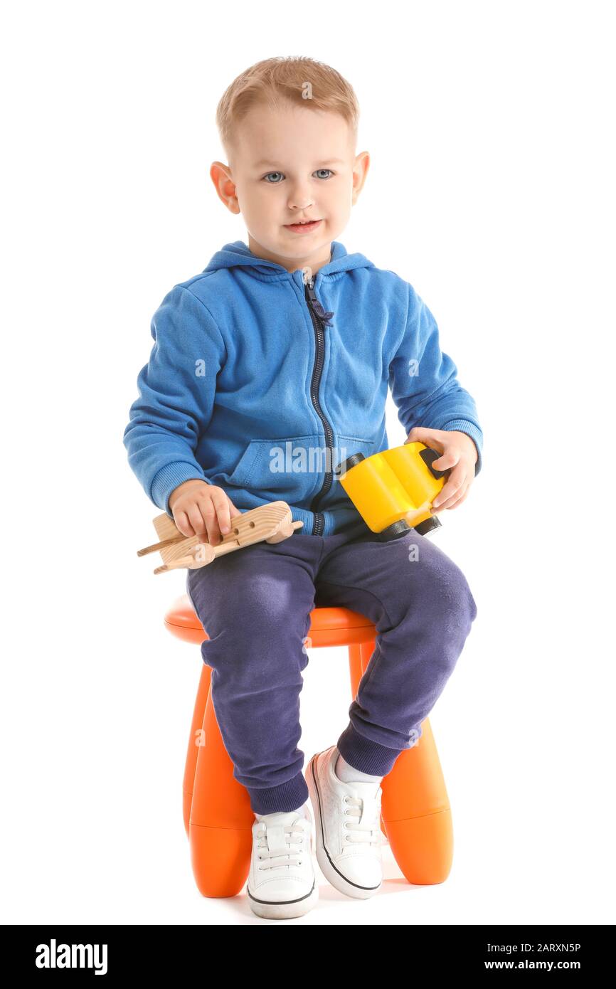 Portrait of cute little boy with toys on white background Stock Photo ...