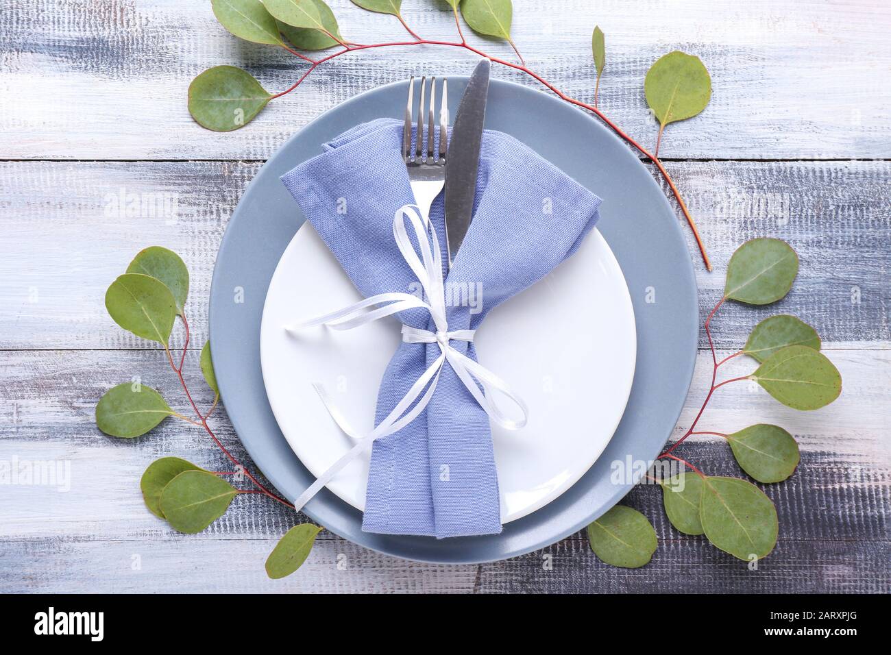 Beautiful table setting with eucalyptus on wooden background Stock ...