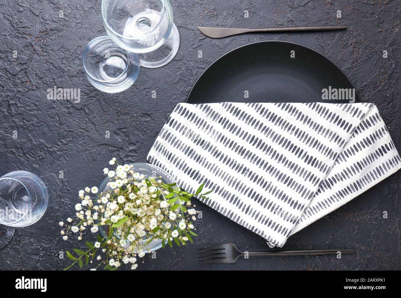 Beautiful table setting on dark background Stock Photo - Alamy