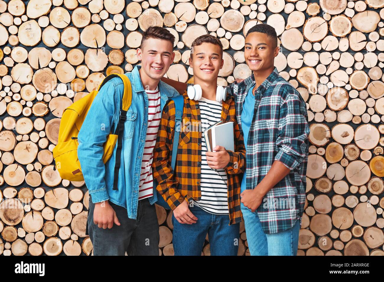 Cool teenage schoolboys on wooden background Stock Photo - Alamy