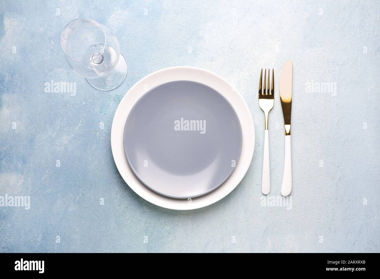 Beautiful table setting on color background Stock Photo - Alamy
