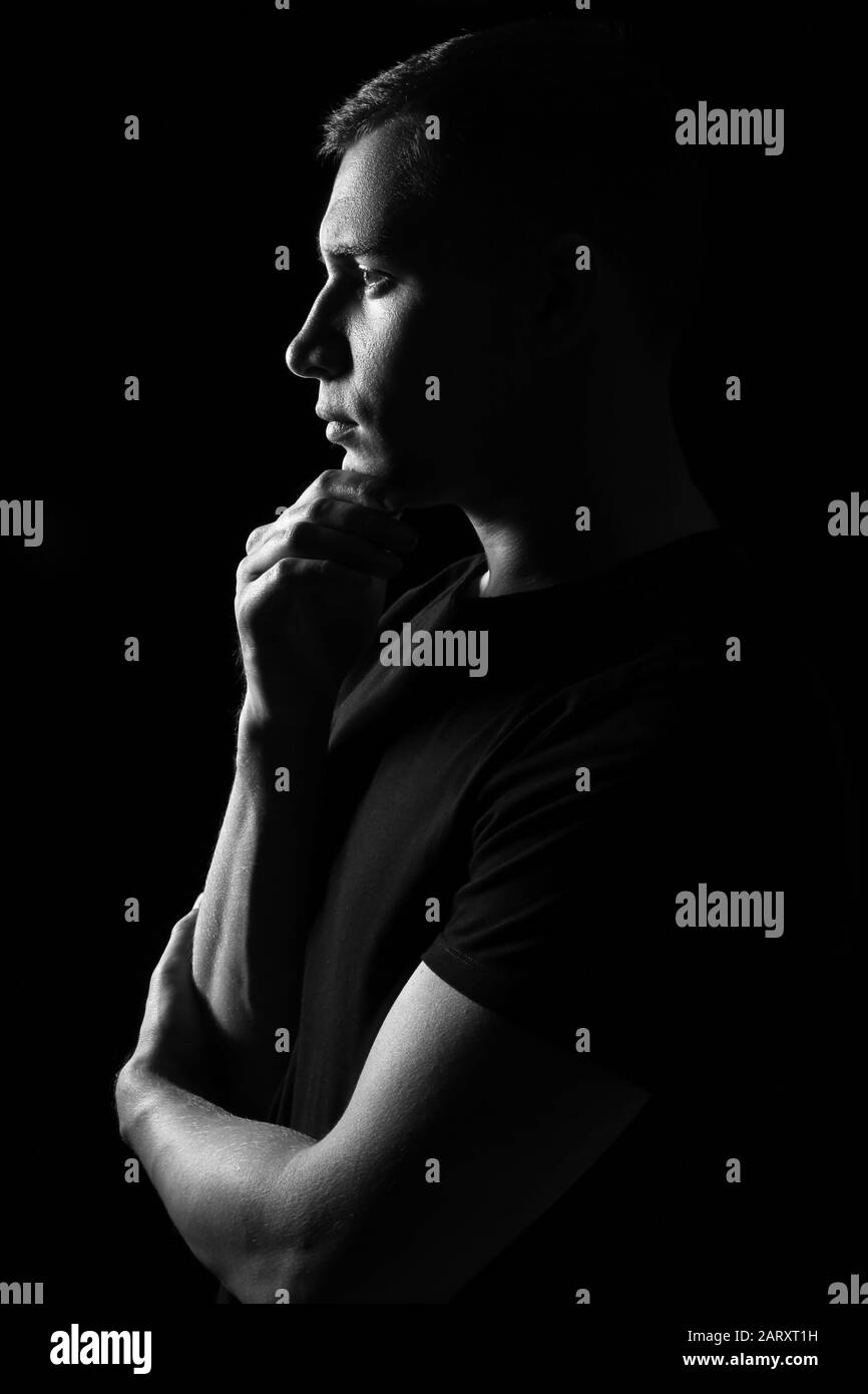Black and white portrait of young man on dark background Stock Photo ...
