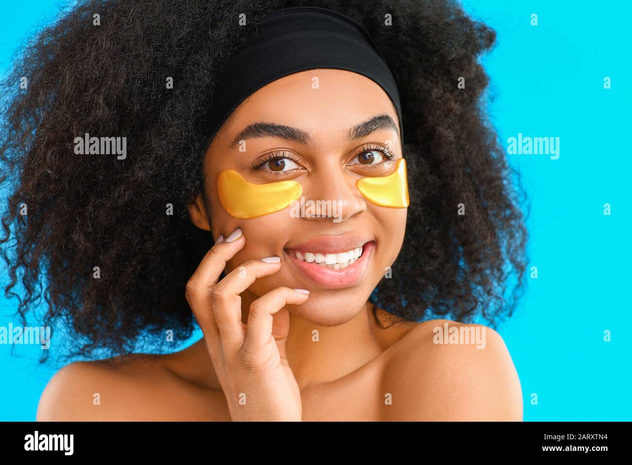 Portrait of beautiful African-American woman with under-eye patches on ...