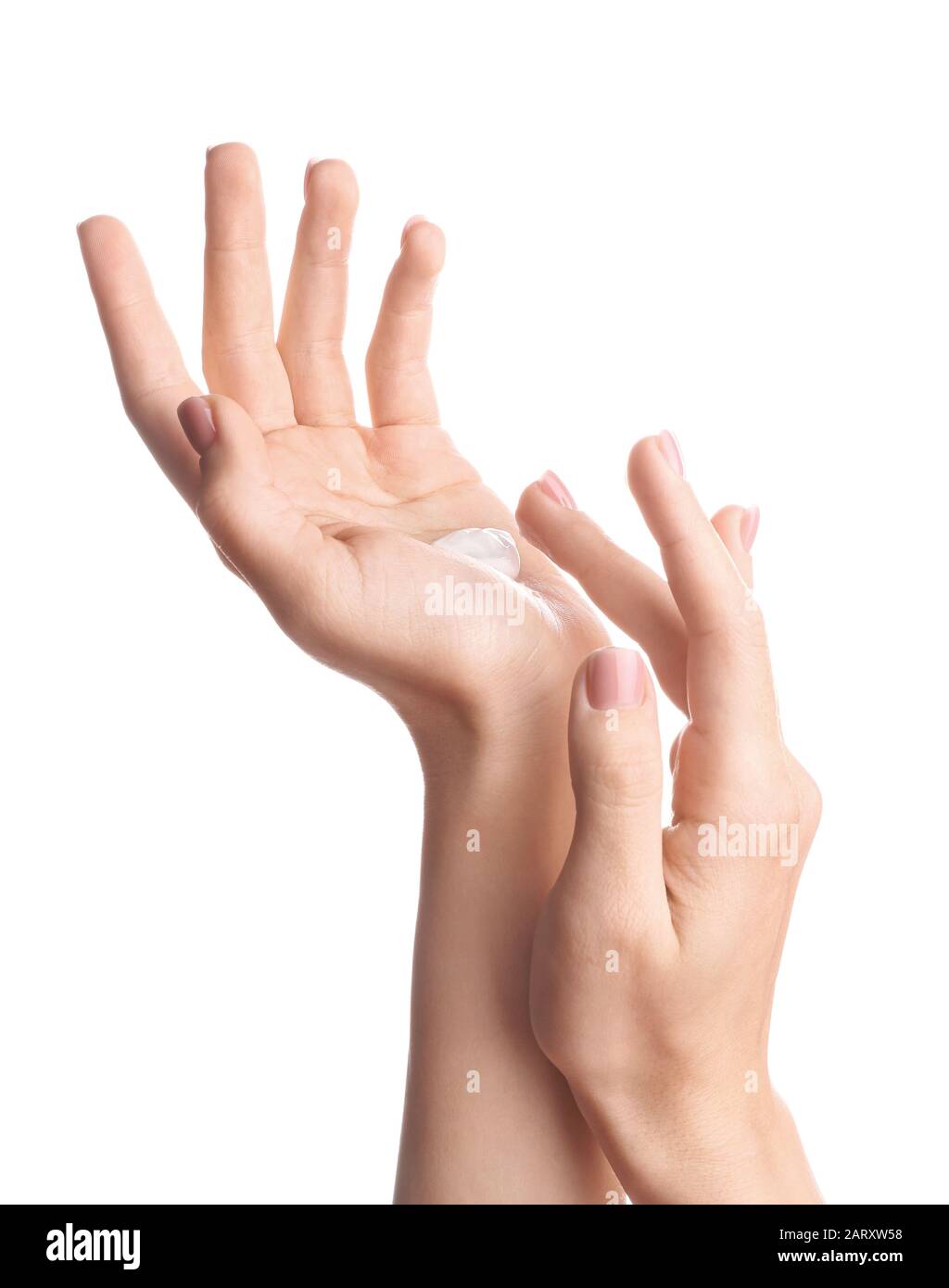 Young woman applying hand cream against white background Stock Photo ...