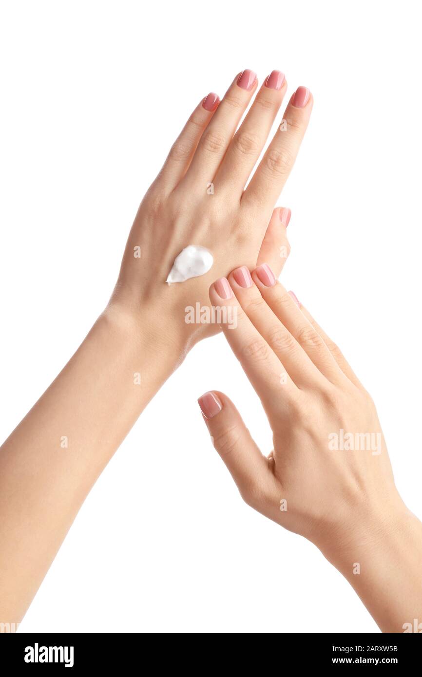 Young woman applying hand cream against white background Stock Photo ...