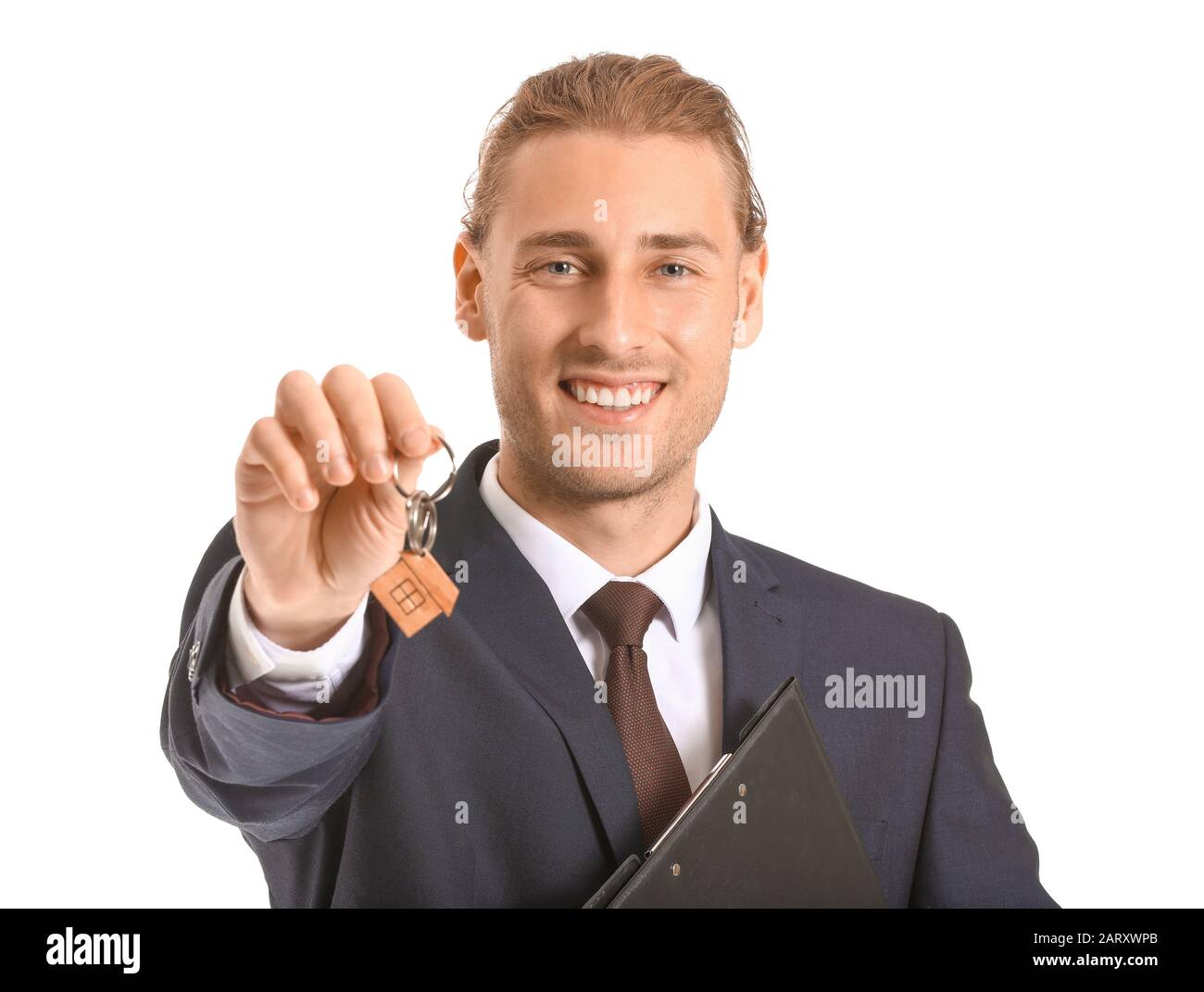 Male real estate agent with key on white background Stock Photo - Alamy