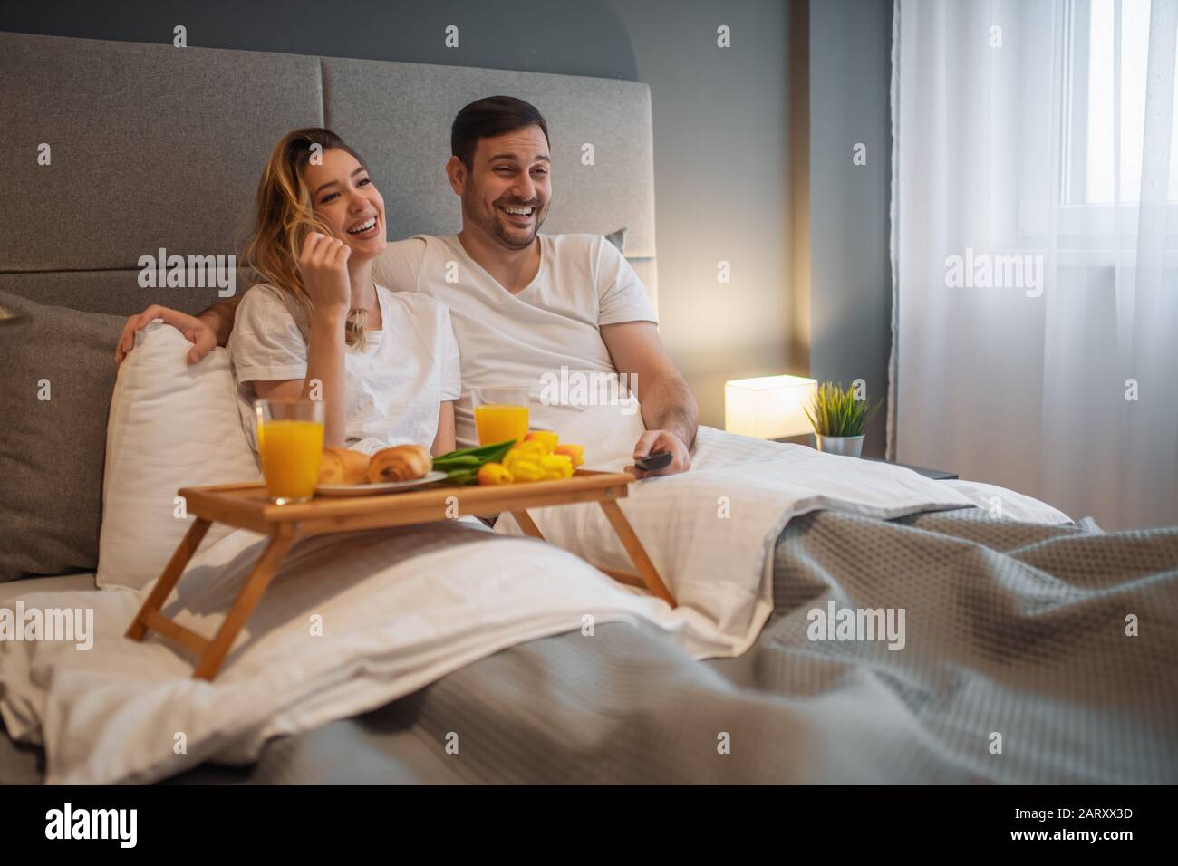 Happy couple having a breakfast in the bed.Romantic moments at home ...