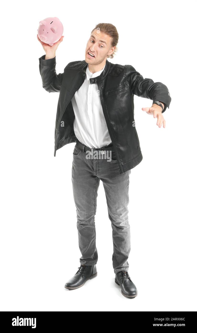 Young man breaking piggy bank on white background Stock Photo - Alamy