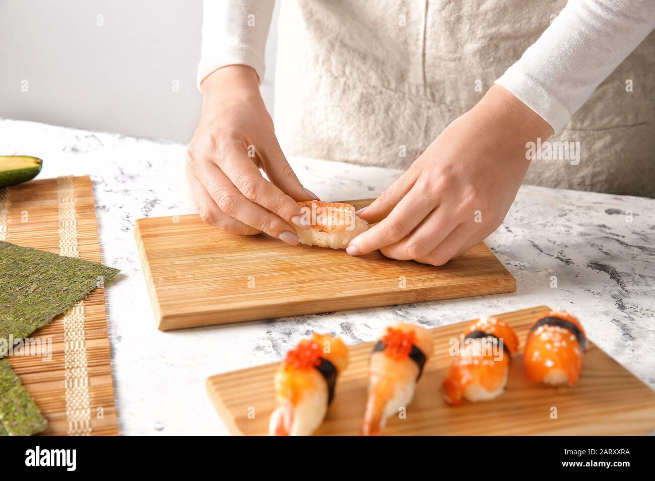 Woman making sushi hi-res stock photography and images - Alamy