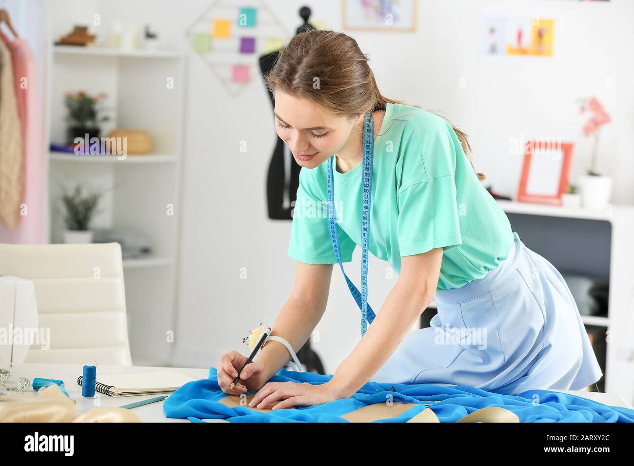 Beautiful female designer working in studio Stock Photo - Alamy