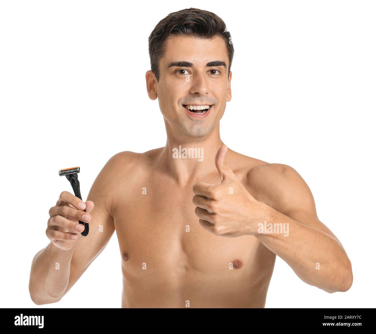 Handsome young man with razor showing thumb-up on white background ...