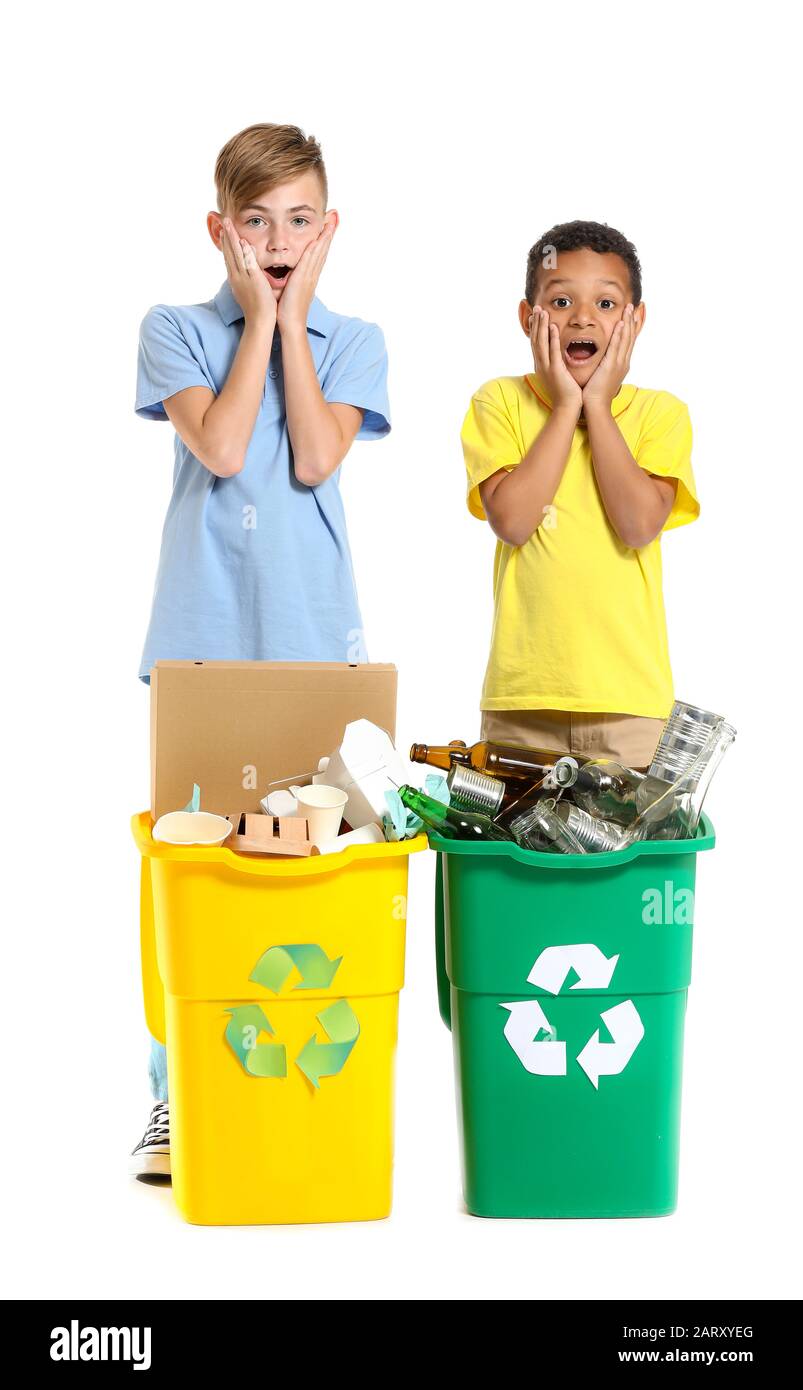 Shocked little boys and containers with trash on white background ...