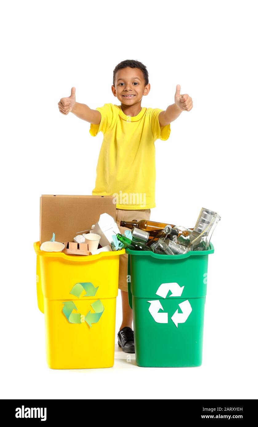 Little African-American boy showing thumb-up near containers with trash ...