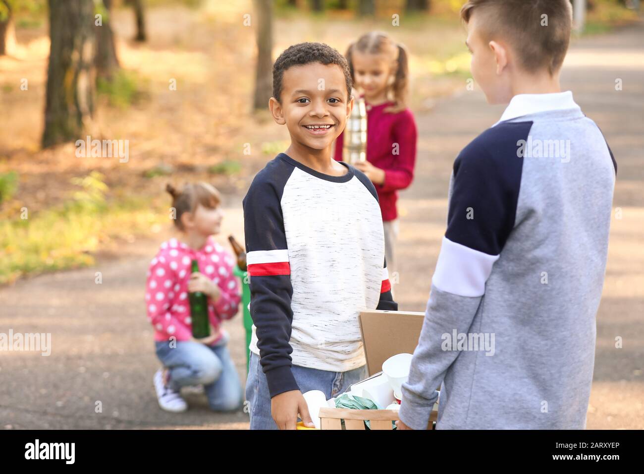 Little children collecting trash outdoors. Concept of recycling Stock ...