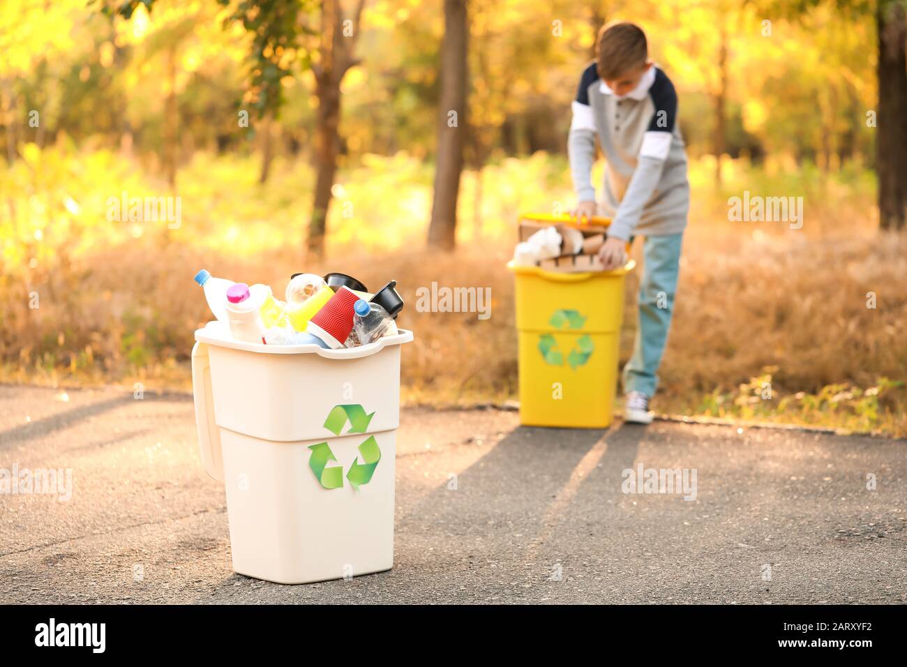 Little boy collecting trash outdoors. Concept of recycling Stock Photo ...