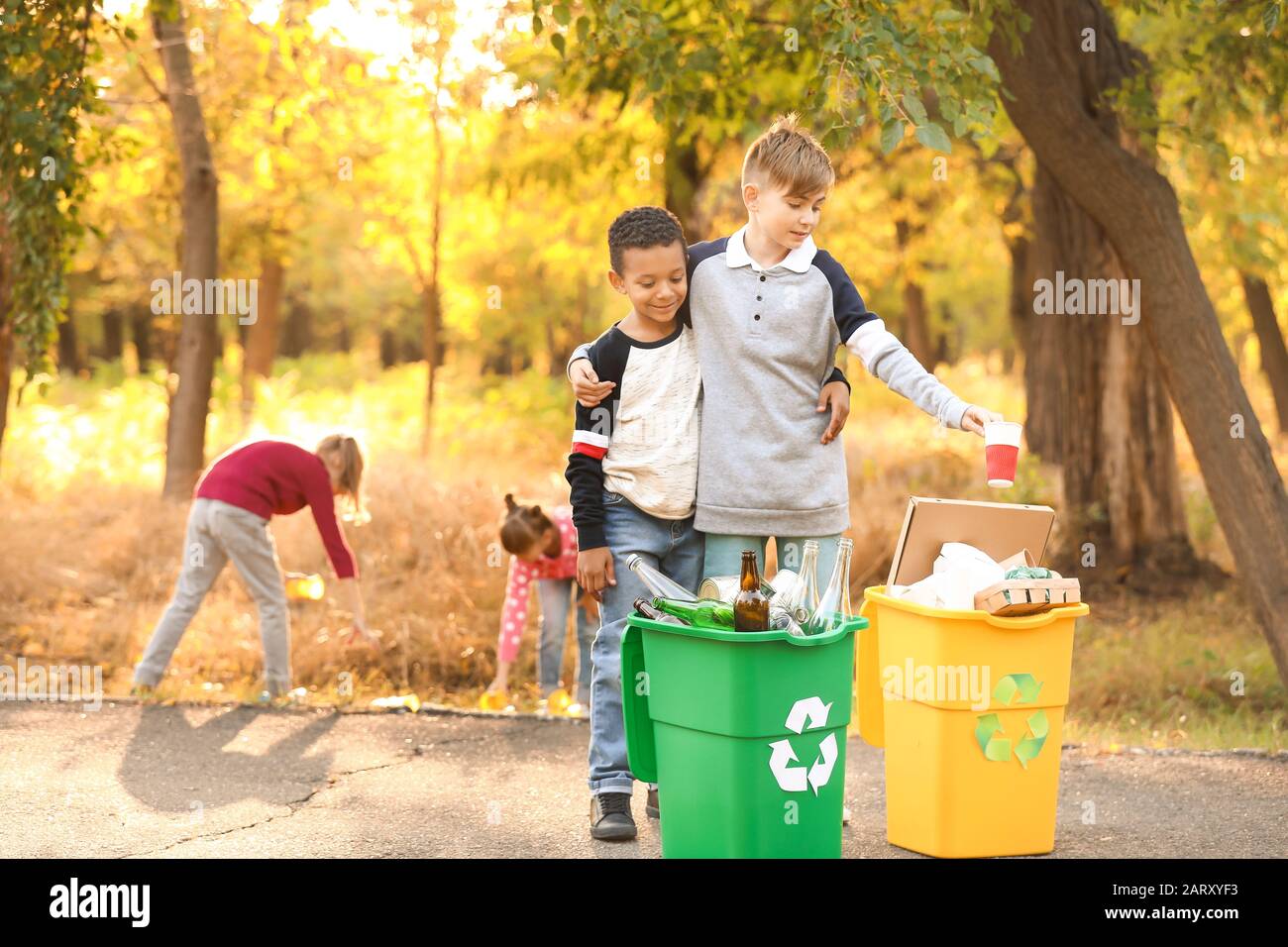 Little children collecting trash outdoors. Concept of recycling Stock ...