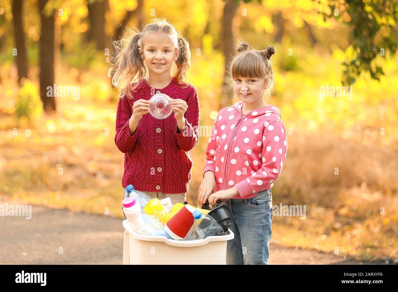 Little children collecting trash outdoors. Concept of recycling Stock ...