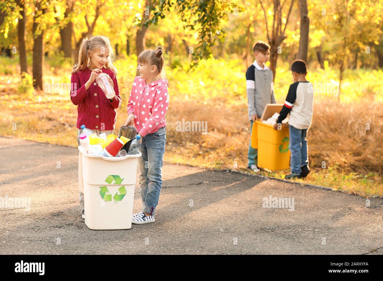 Little children collecting trash outdoors. Concept of recycling Stock ...
