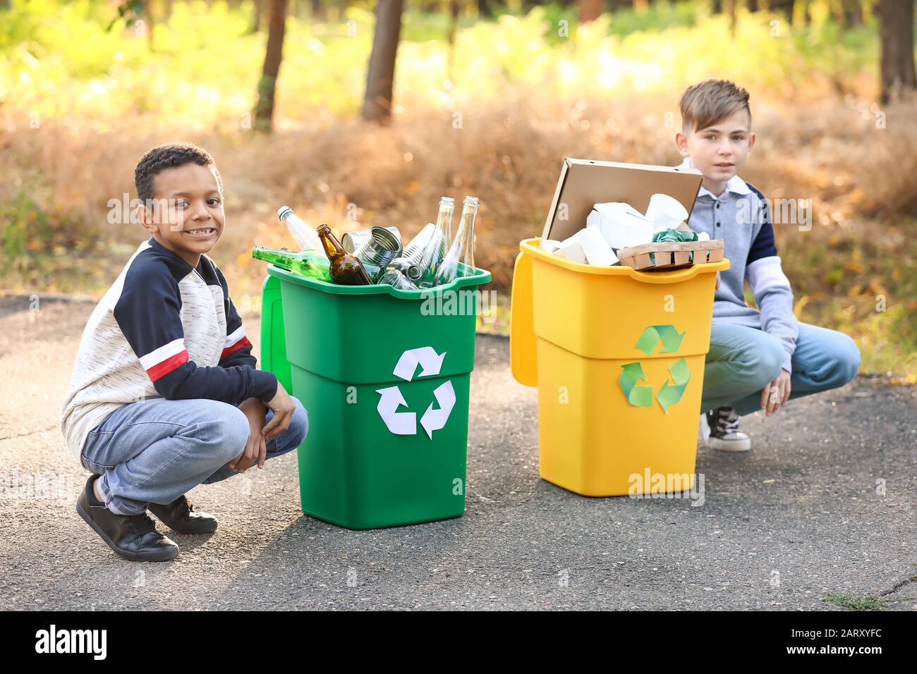 Little children collecting trash outdoors. Concept of recycling Stock ...