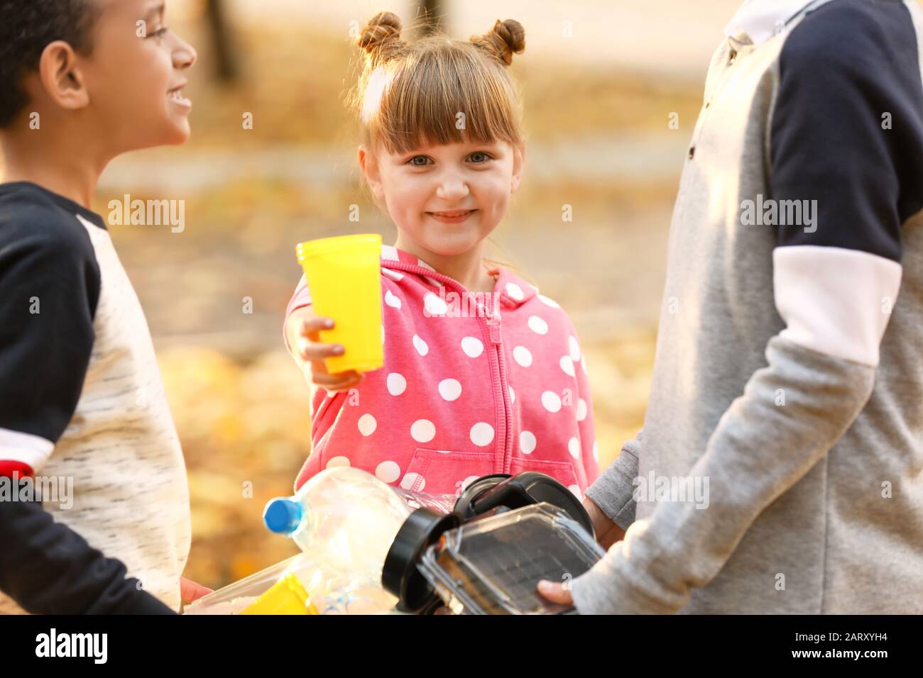 Little children collecting trash outdoors. Concept of recycling Stock ...