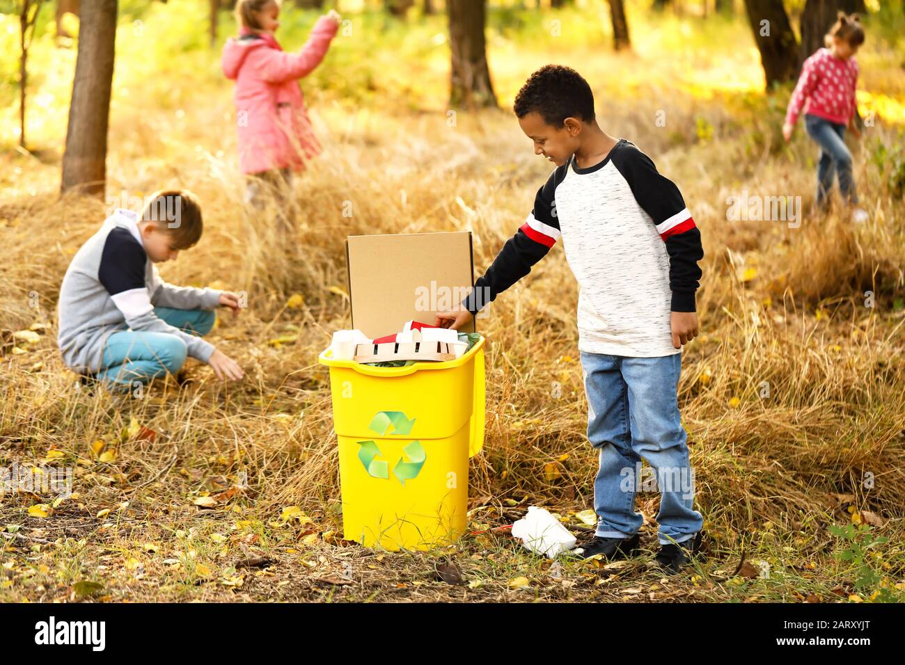 Little children collecting trash outdoors. Concept of recycling Stock ...