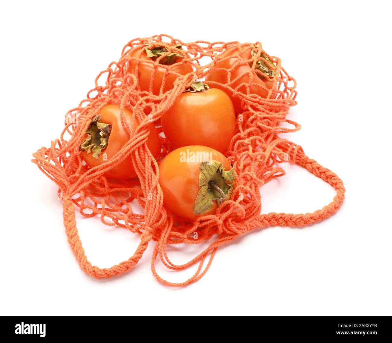 Bag with ripe persimmons on white background Stock Photo - Alamy