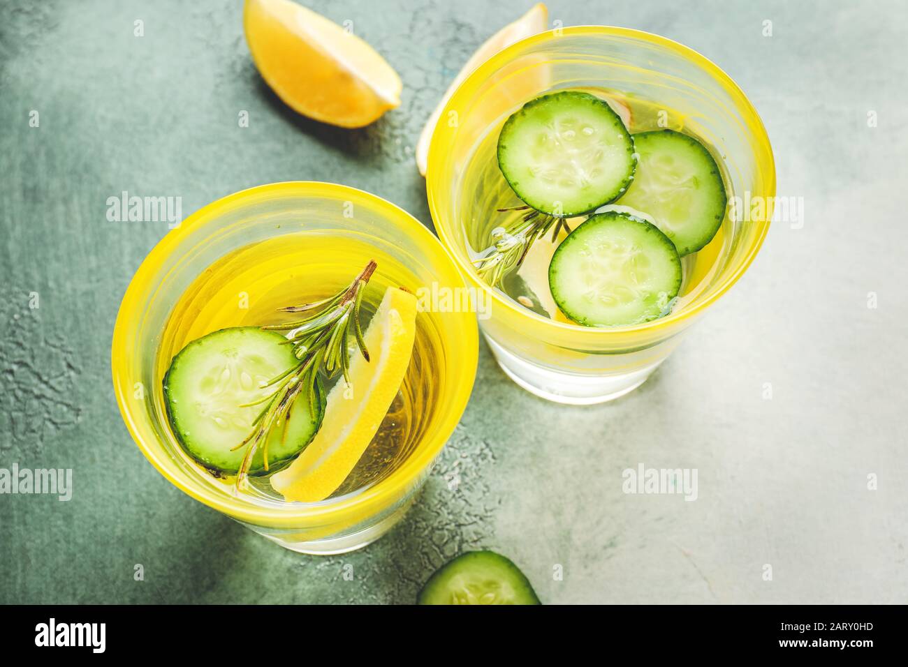 Glasses of cold cucumber water on color background Stock Photo - Alamy