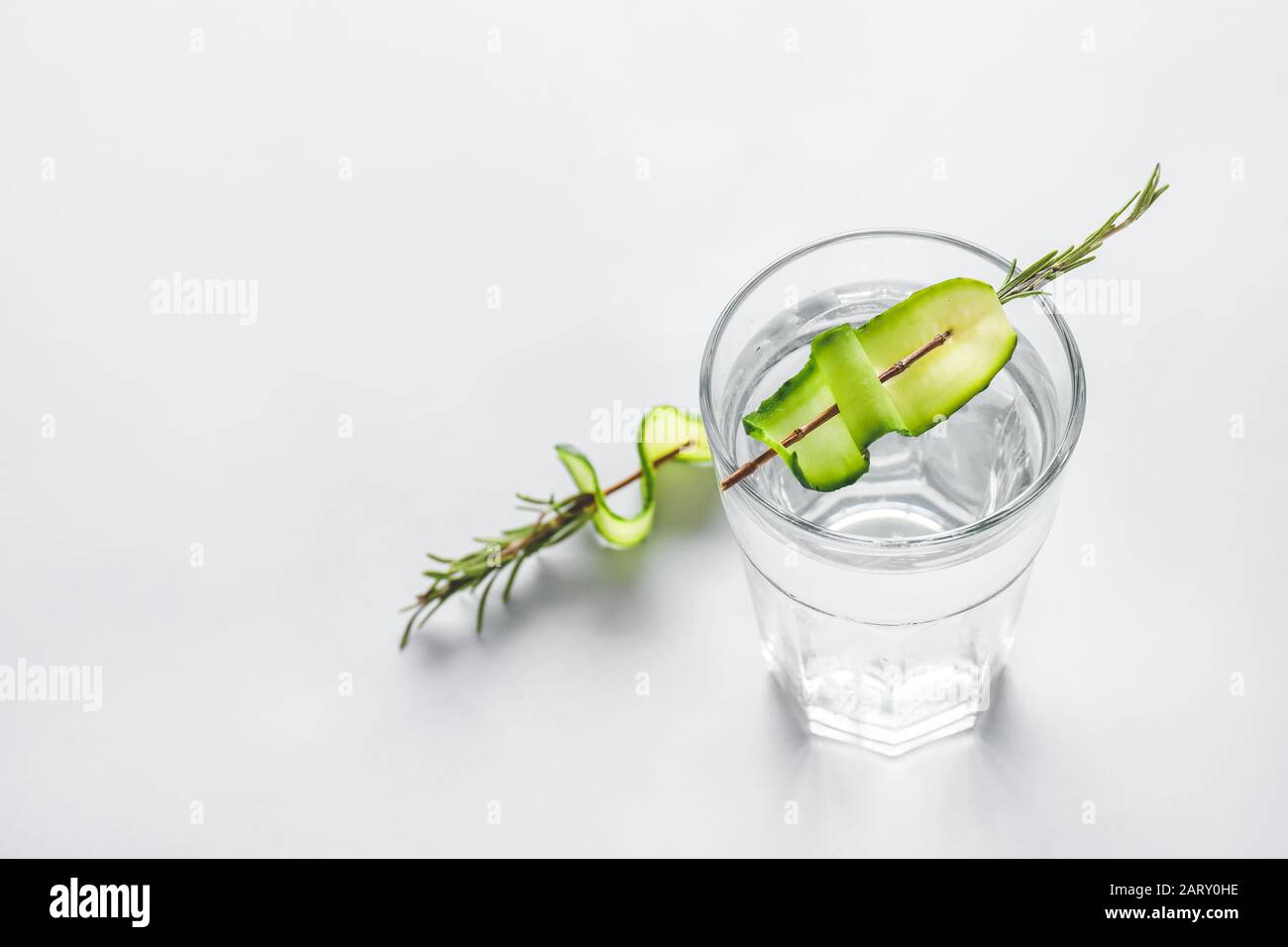 Glass of cold cucumber water on light background Stock Photo - Alamy