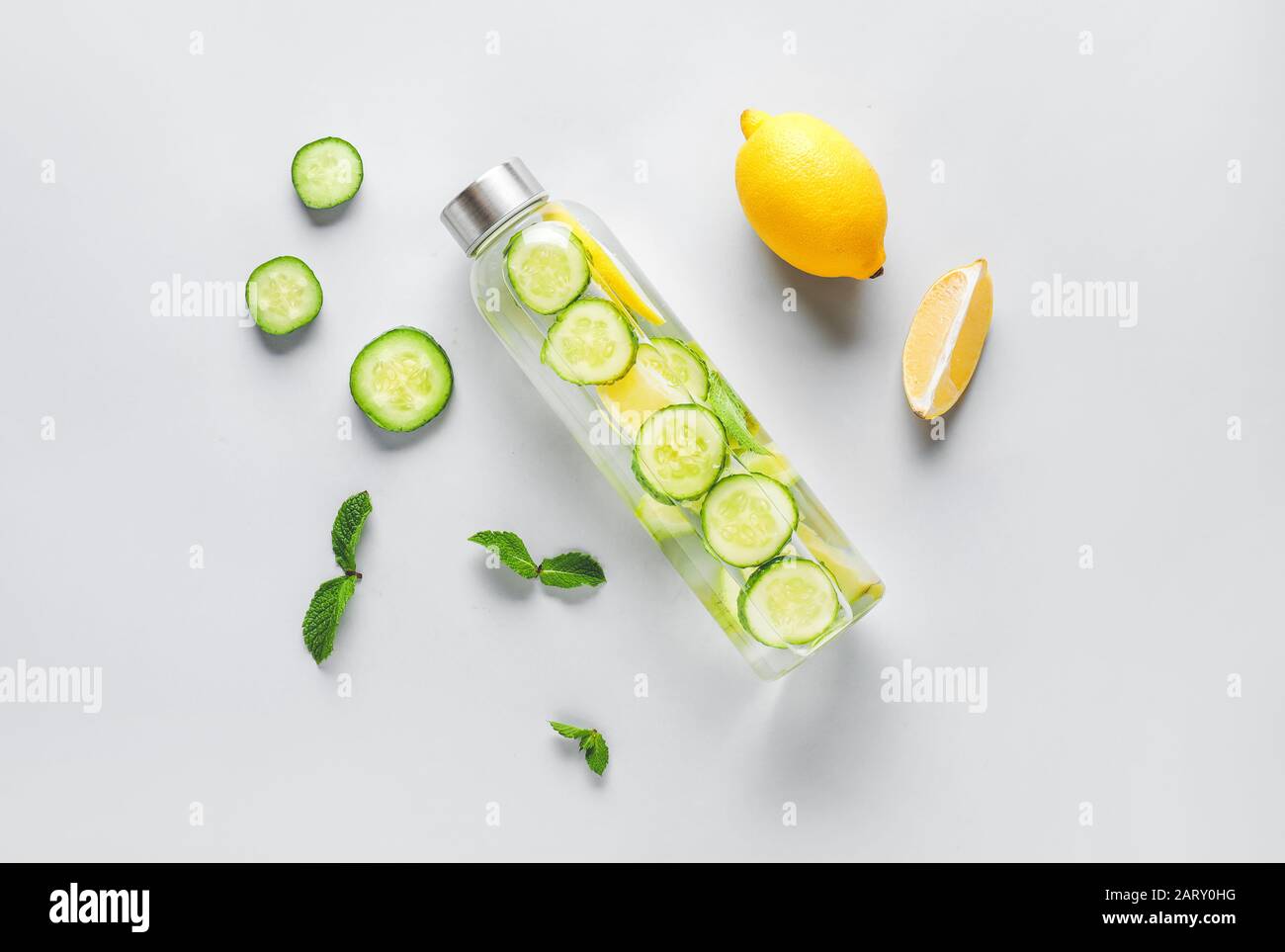 Bottle of cold cucumber water on light background Stock Photo - Alamy